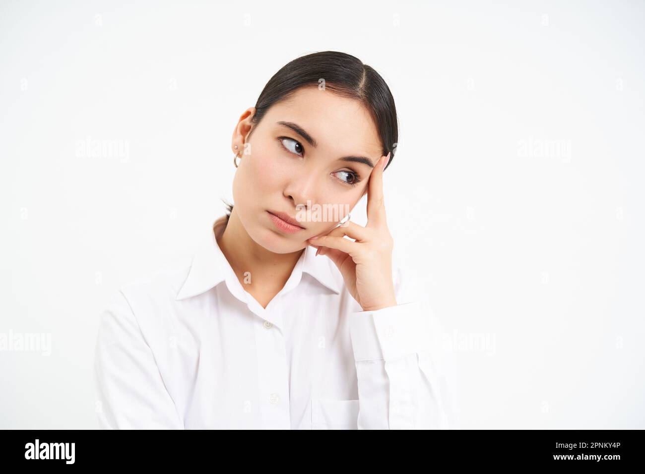 Portrait of annoyed, bored korean woman roll eyes, looks aside with ...