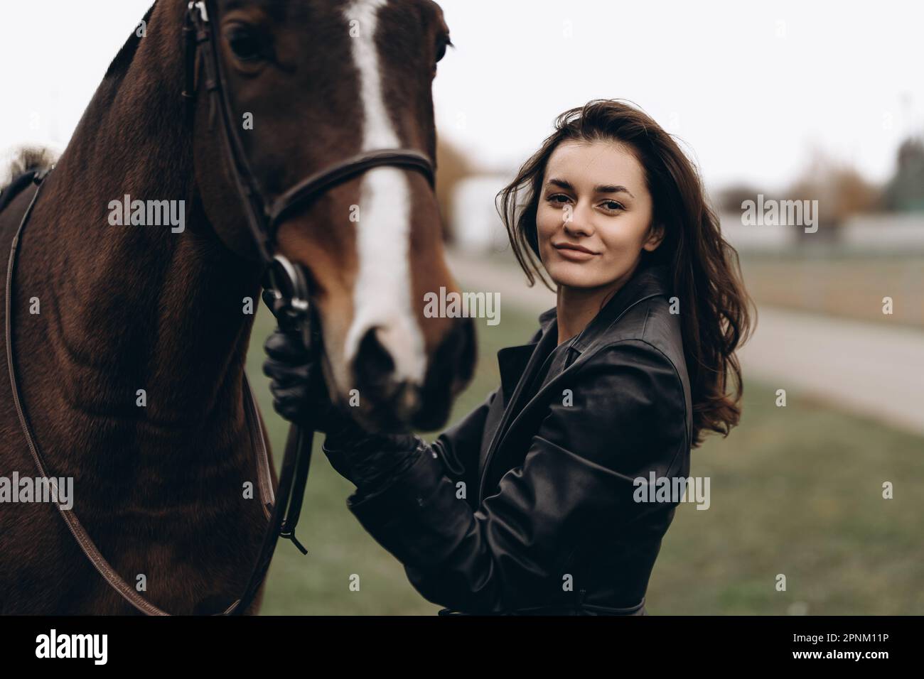A young equestrian in uniform poses with a beautiful, majestic horse ...