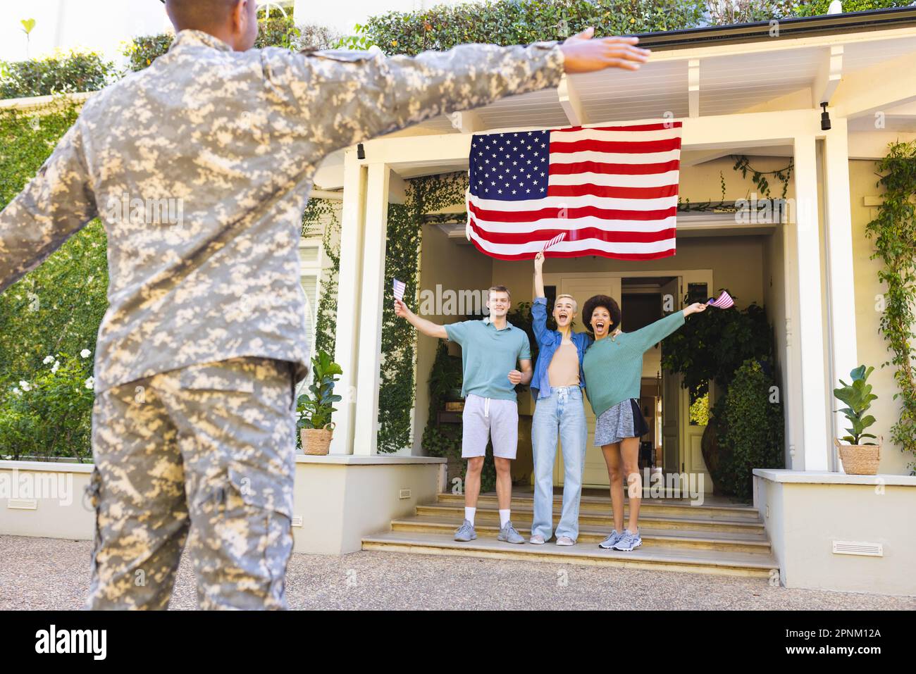 Happy diverse group of friends with usa flags, greeting biracial male ...
