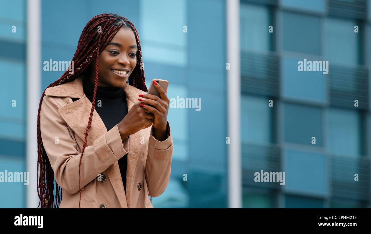 Excited enthusiastic surprised african american woman winner outdoors ...