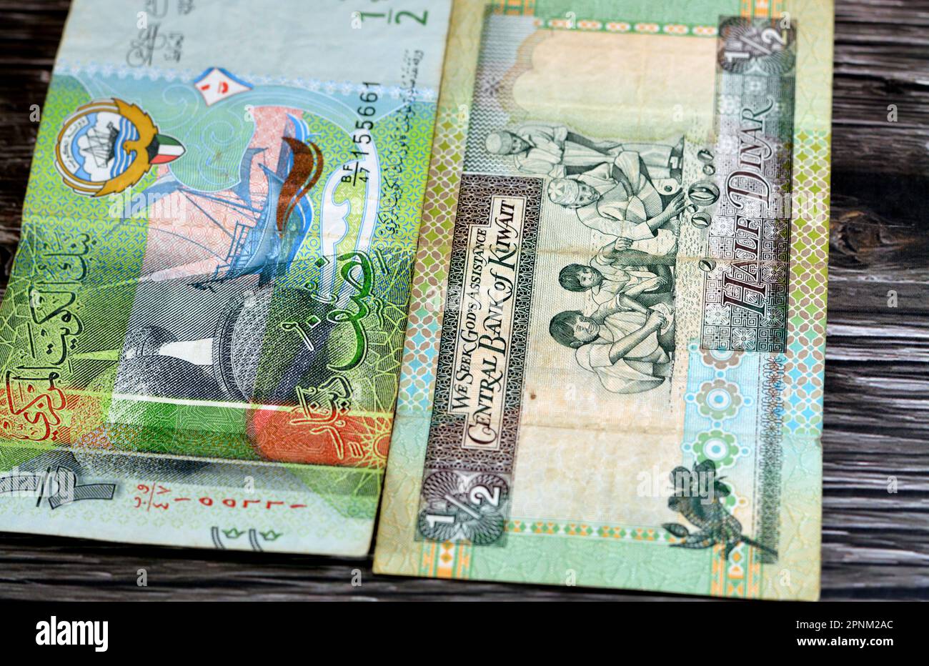 Old and new Kuwaiti half dinar bill banknotes money coat of arms of ...