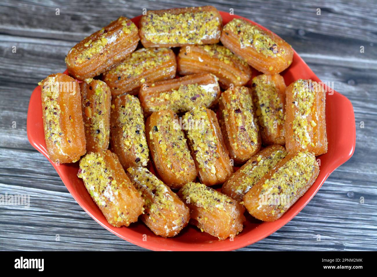 Tulumba, Bamiyeh or Balah El Sham stuffued with whipped cream and ...