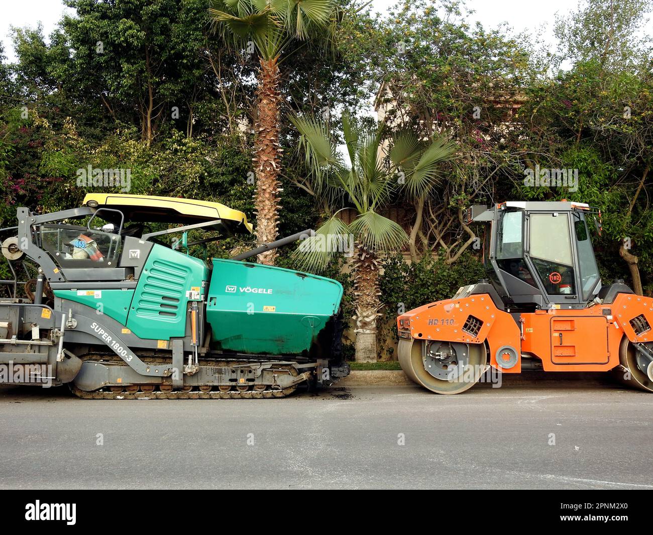Cairo, Egypt, April 7 2023: Asphalt paver trucks and compactors, A ...