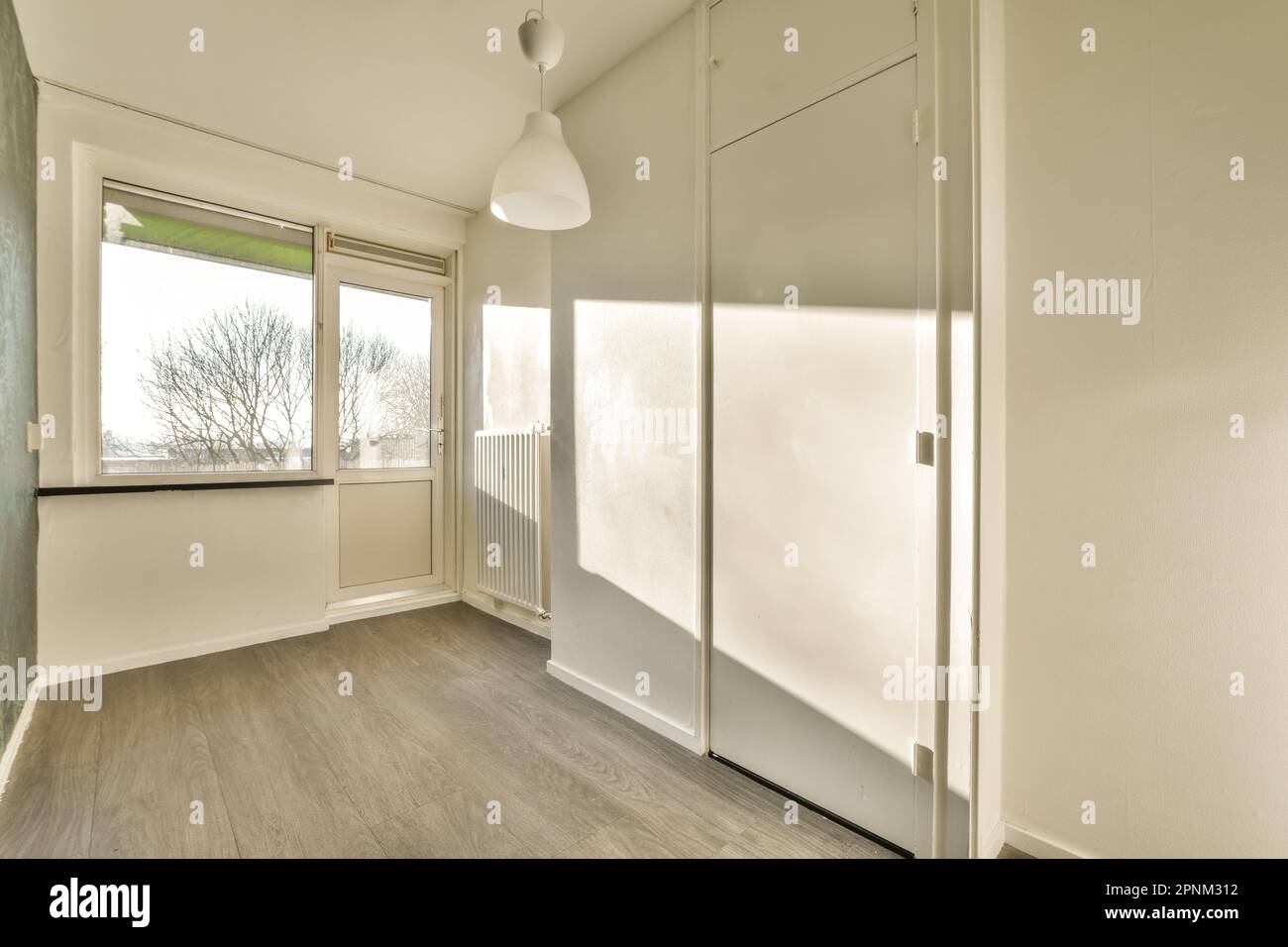 an empty room with wood flooring and sliding doors in the middle of the ...