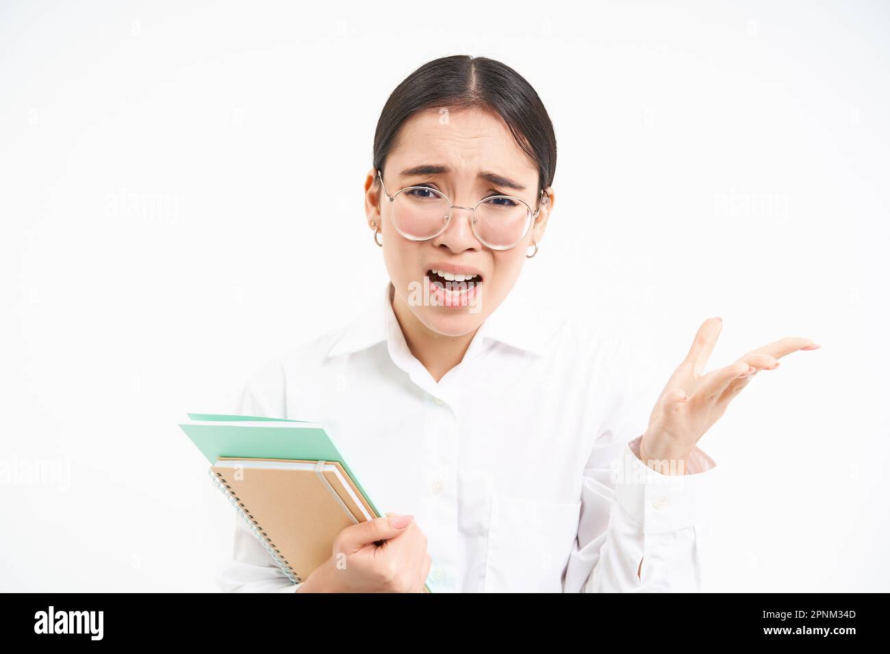 Frustrated young woman, teacher screams ad looks confused, stares ...