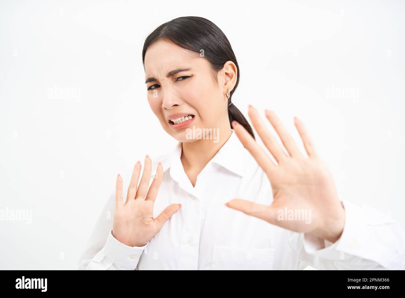Disgusted korean woman, covers and protects herself with hands, steps ...