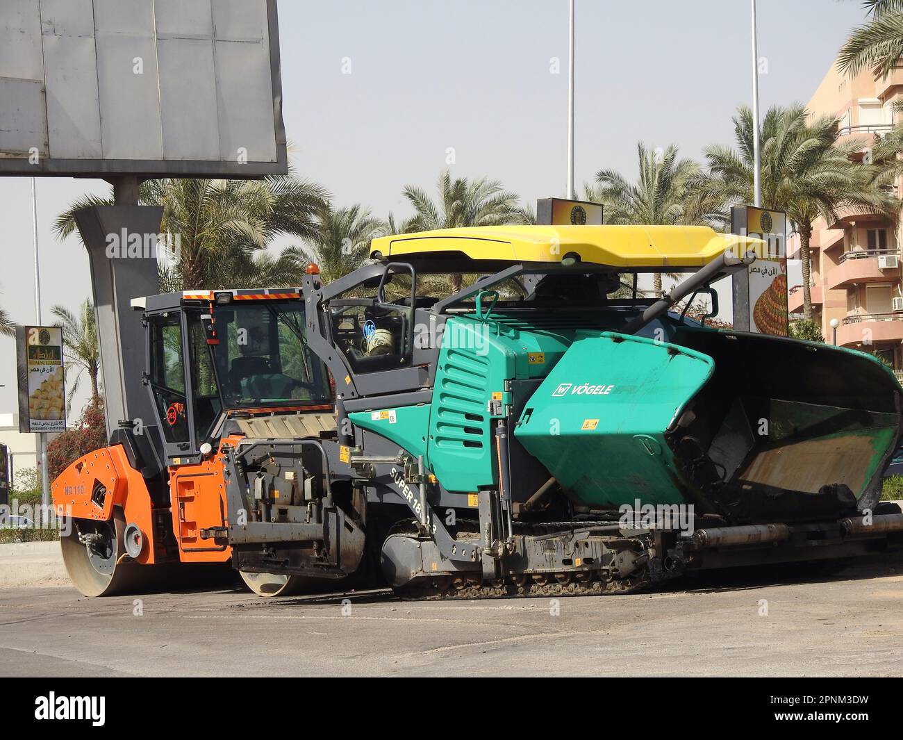 Cairo, Egypt, April 18 2023: Asphalt paver trucks and compactors, A ...