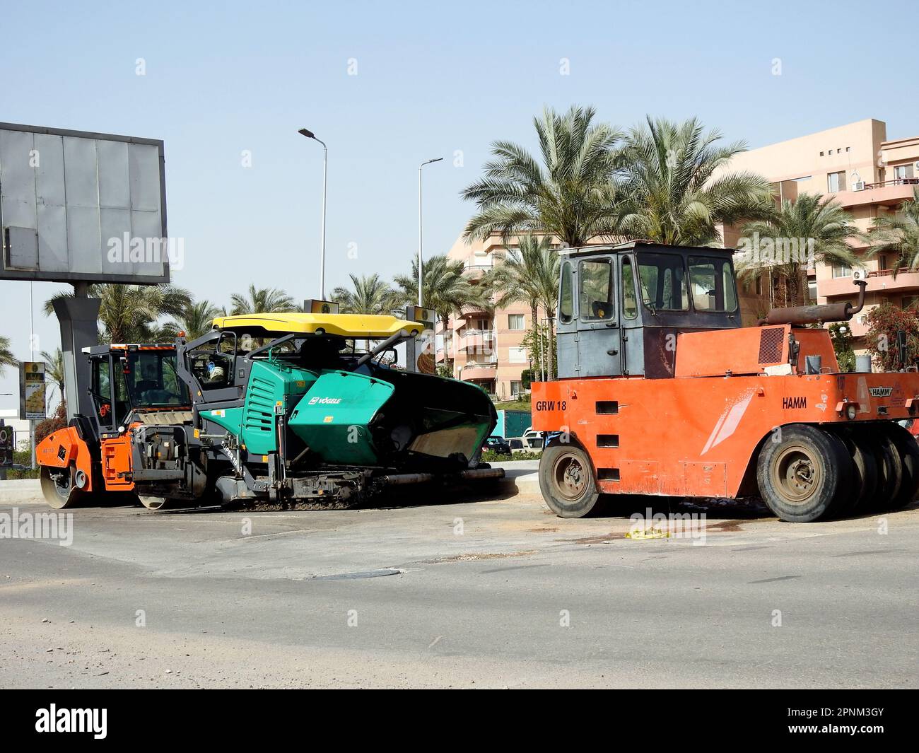 Cairo, Egypt, April 18 2023: Asphalt paver trucks and compactors, A ...