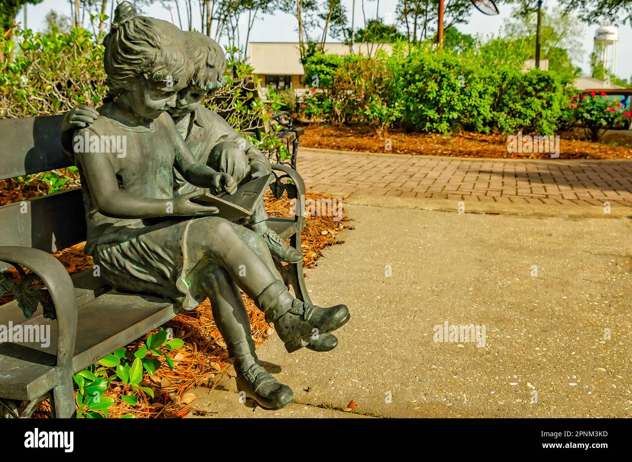 A bronze sculpture of two children reading is pictured at Bay Minette ...