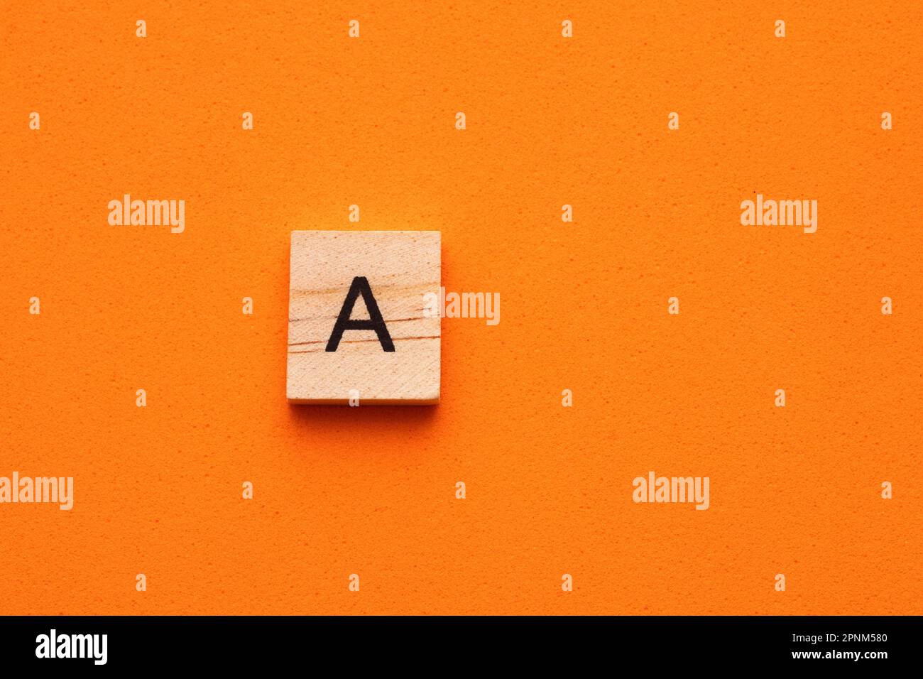 Alphabet letter A on wooden square tile - Orange foamy background Stock ...