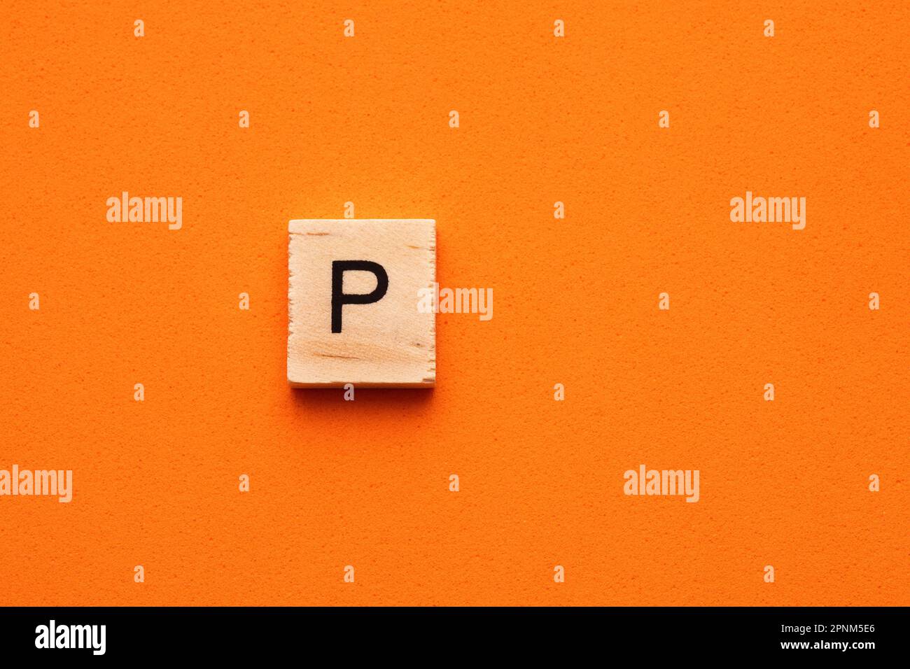 Alphabet capital letter P on wooden square tile - Orange foamy ...