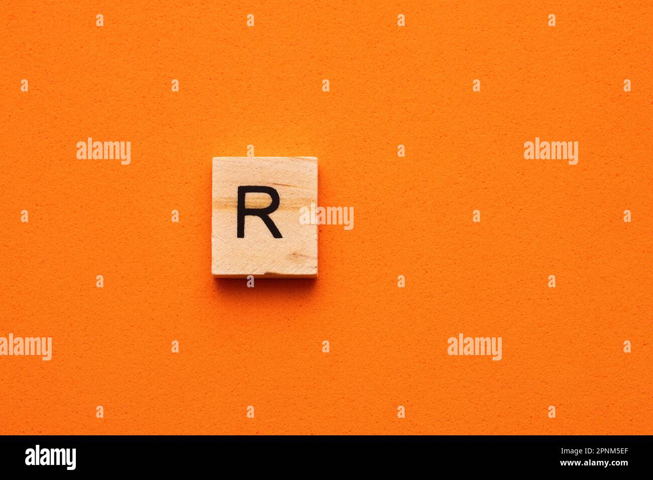 Alphabet capital letter R on wooden square tile - Orange foamy ...