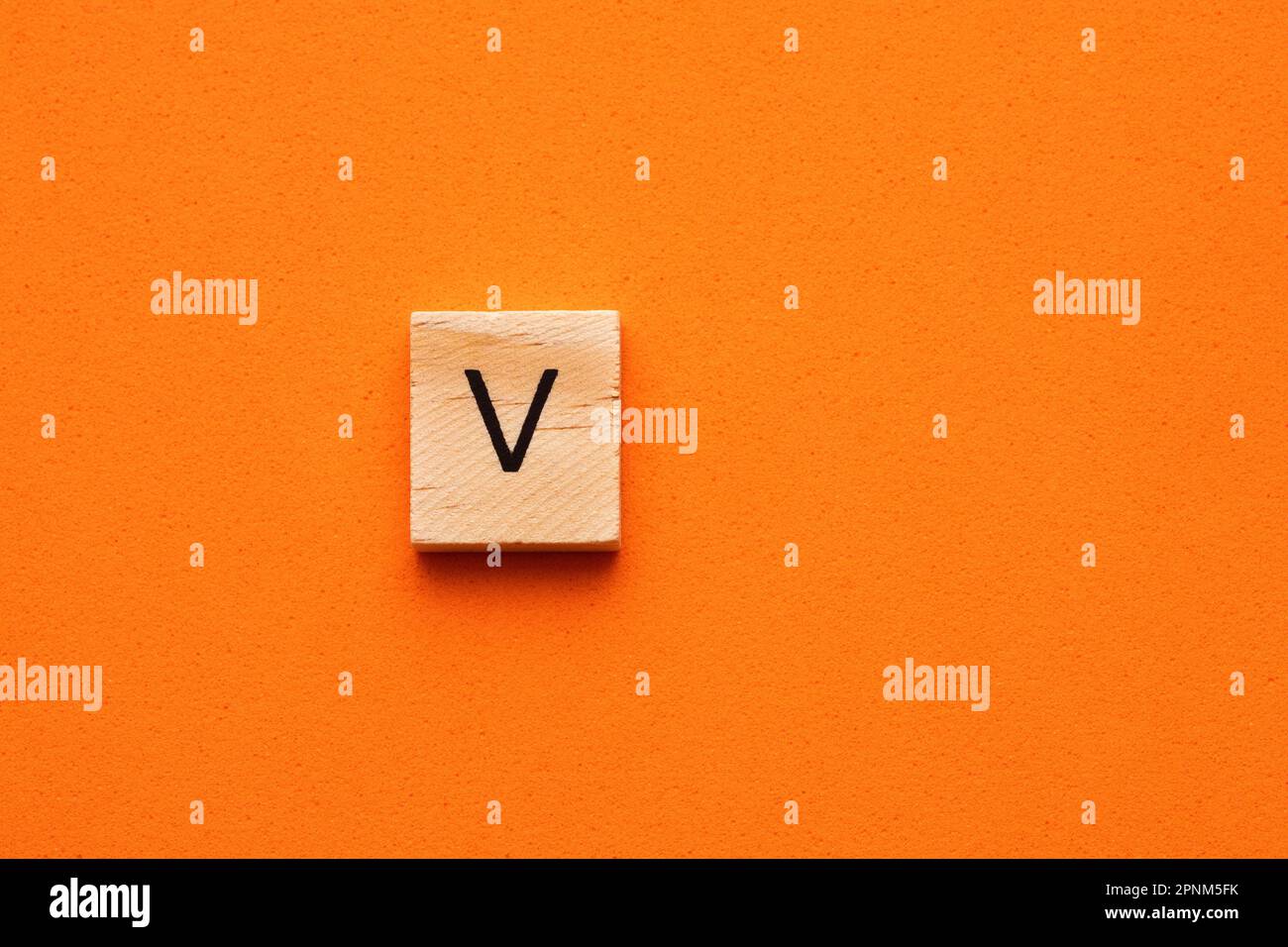 Alphabet capital letter V on wooden square tile - Orange foamy ...