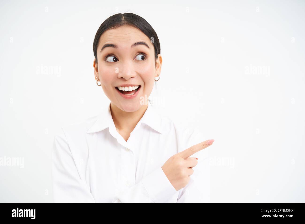 Successful korean businesswoman, pointing finger right, showing ...