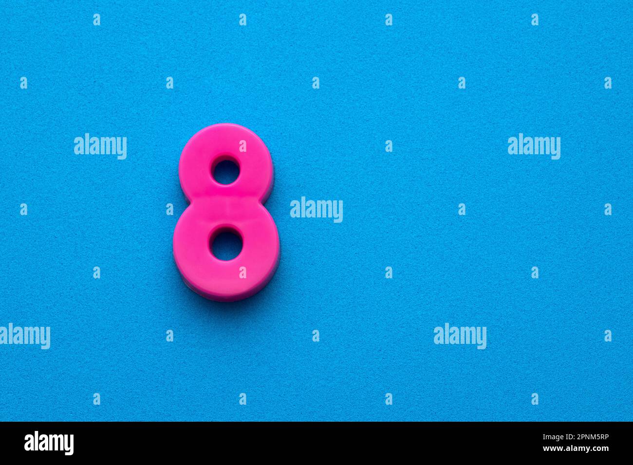 Number eight color pink (8) - Plastic digit on blue foamy colored ...