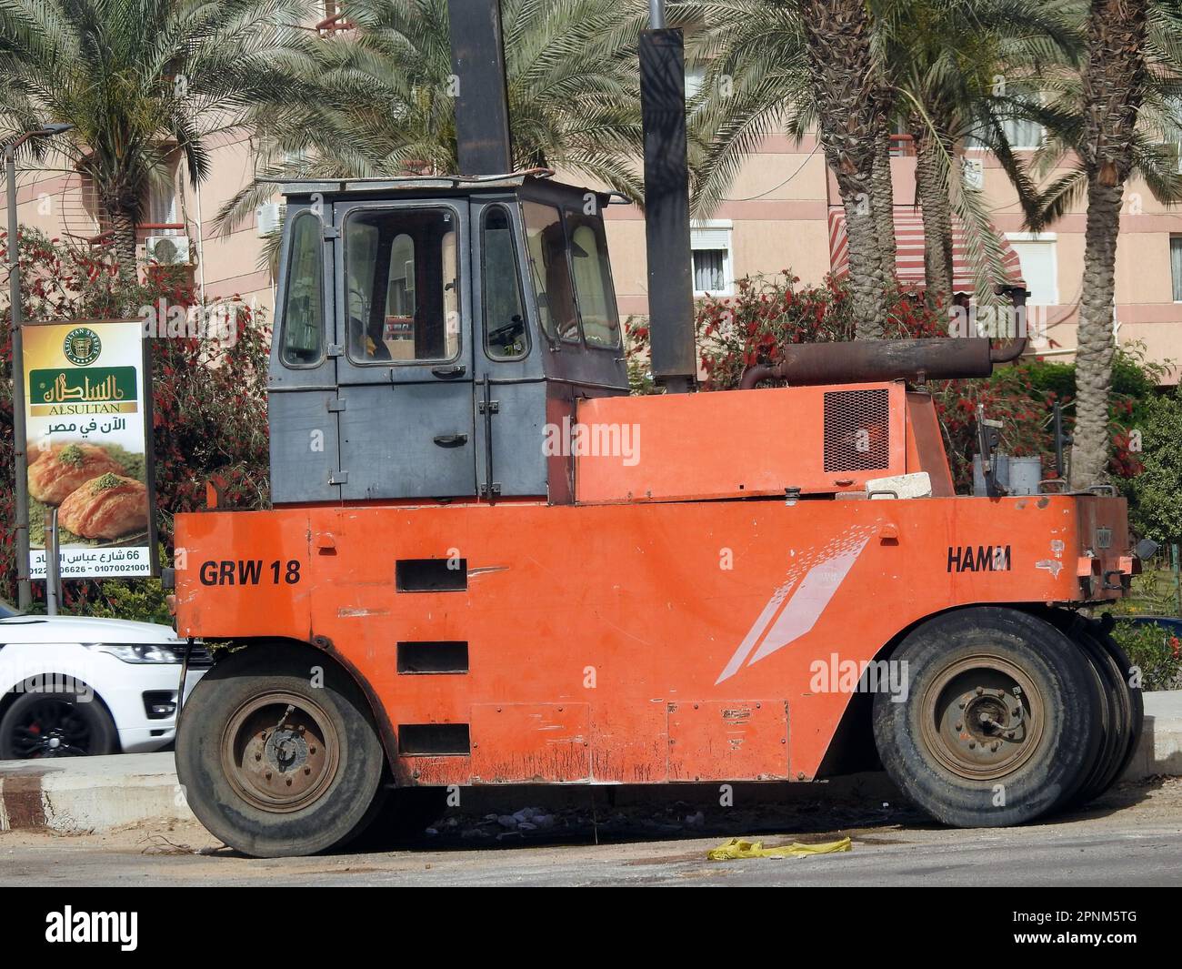 Cairo, Egypt, April 18 2023: Wheeled Asphalt compactor paver truck, A ...