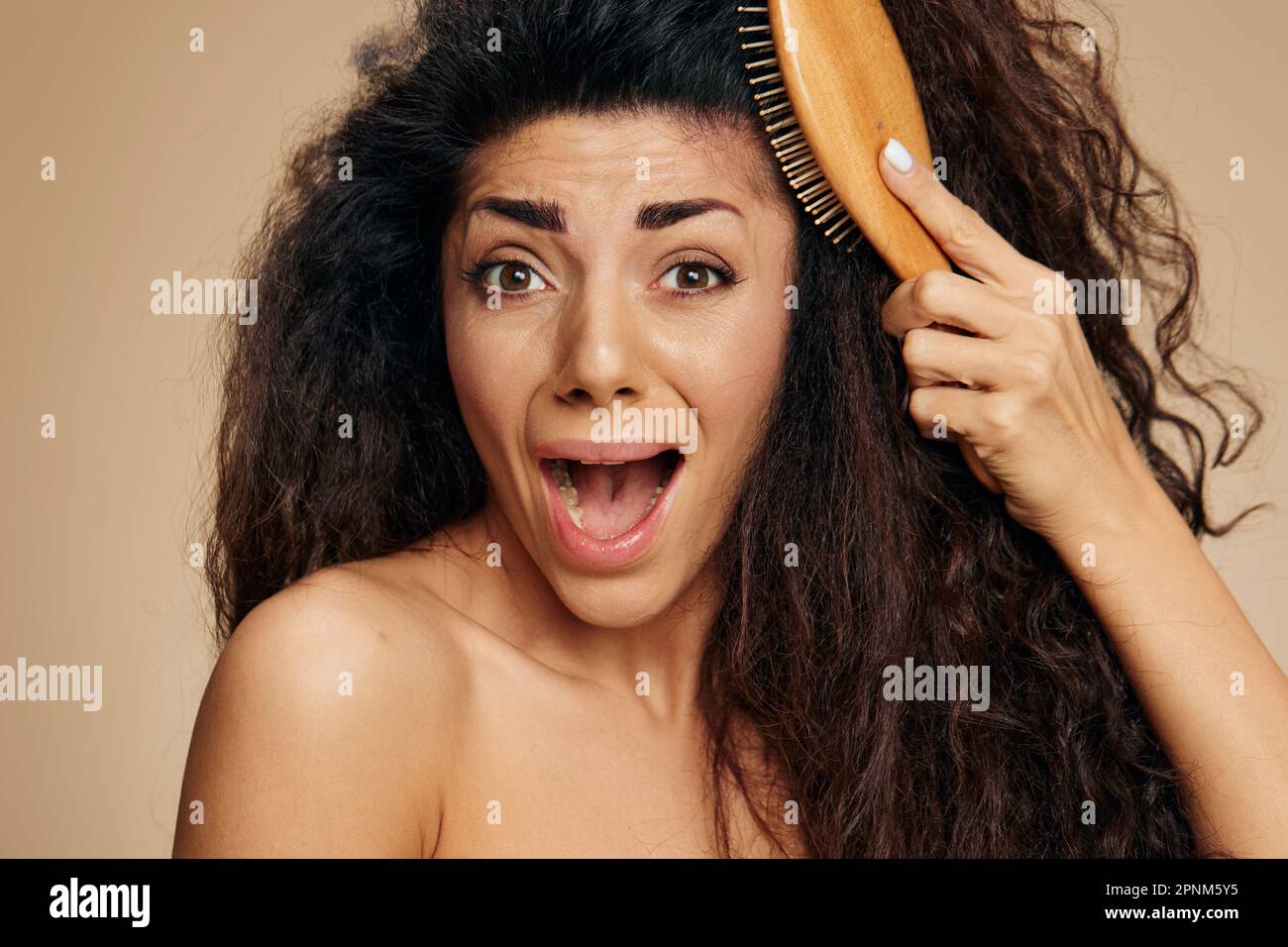 TANGLED LONG HAIR CONCEPT. Crying suffering awesome curly Latin lady ...