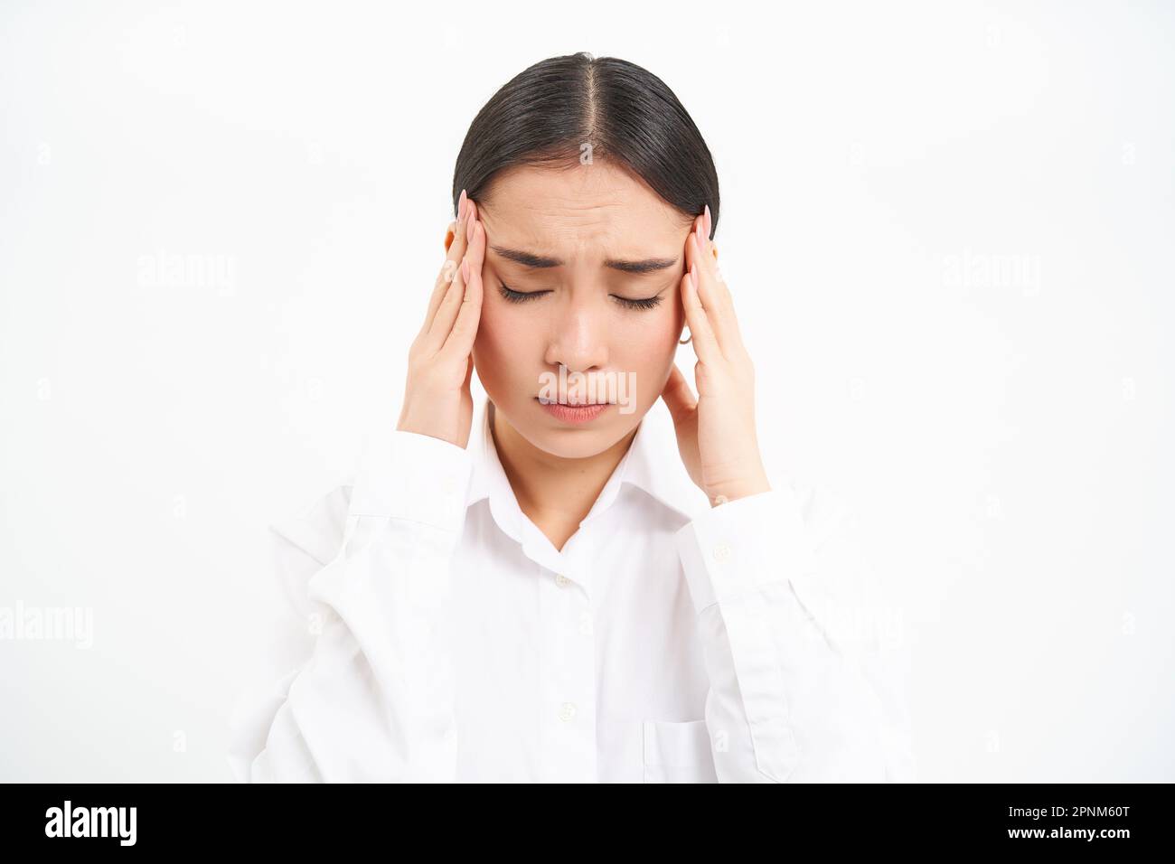 Tired woman, office worker holds hands on head, migraine or headache ...