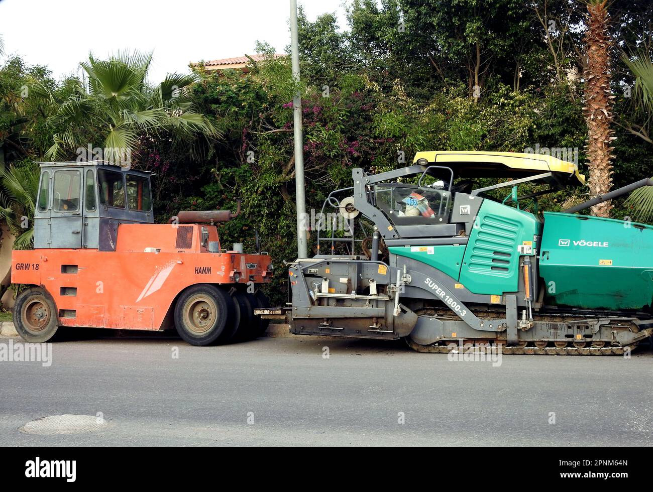 Cairo, Egypt, April 7 2023: Asphalt paver trucks and compactors, A ...