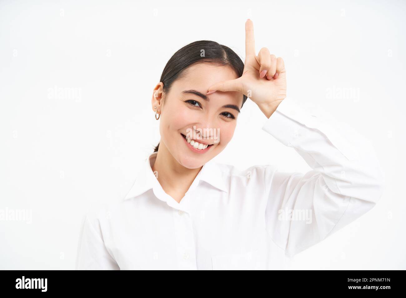 Asian woman shows L letter, loser on forehead and smiling, winner mocks ...