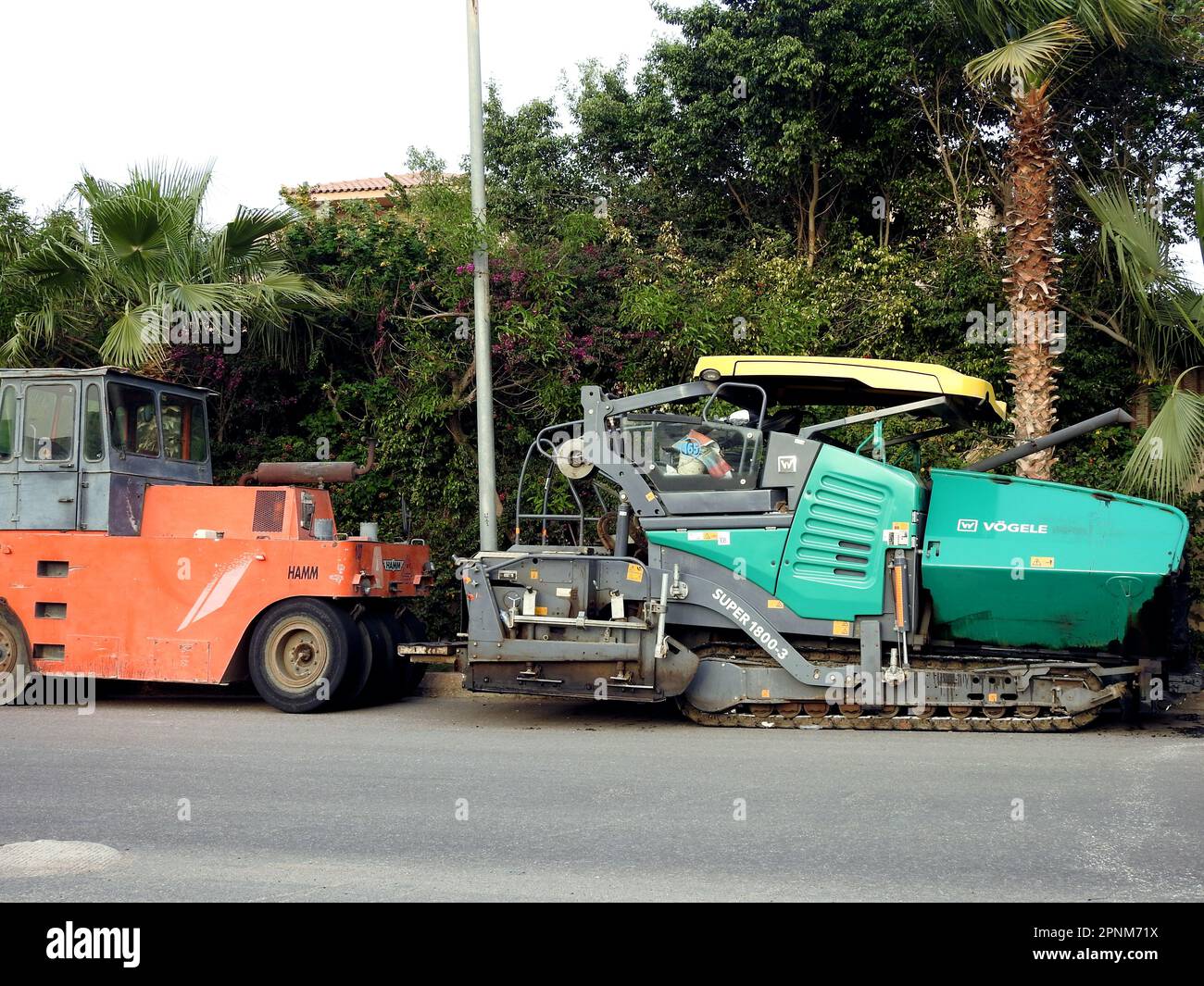 Cairo, Egypt, April 7 2023: Asphalt paver trucks and compactors, A ...