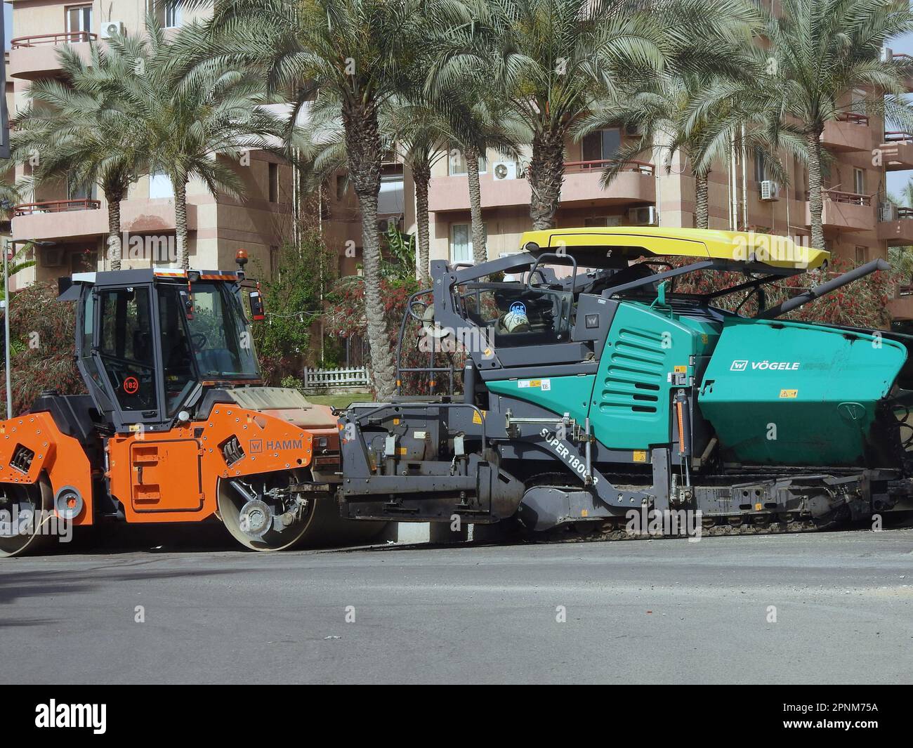Cairo, Egypt, April 18 2023: Asphalt paver trucks and compactors, A ...