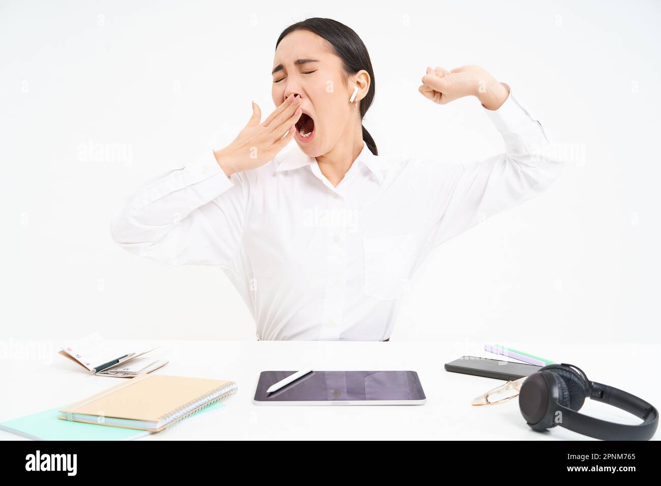 Tired businesswoman in office, sits back and stretches hands, exhausted ...