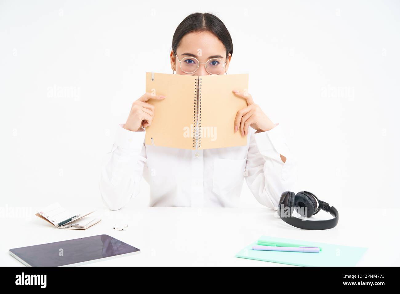 Image of hardworking student, asian woman in glasses studying, holding ...