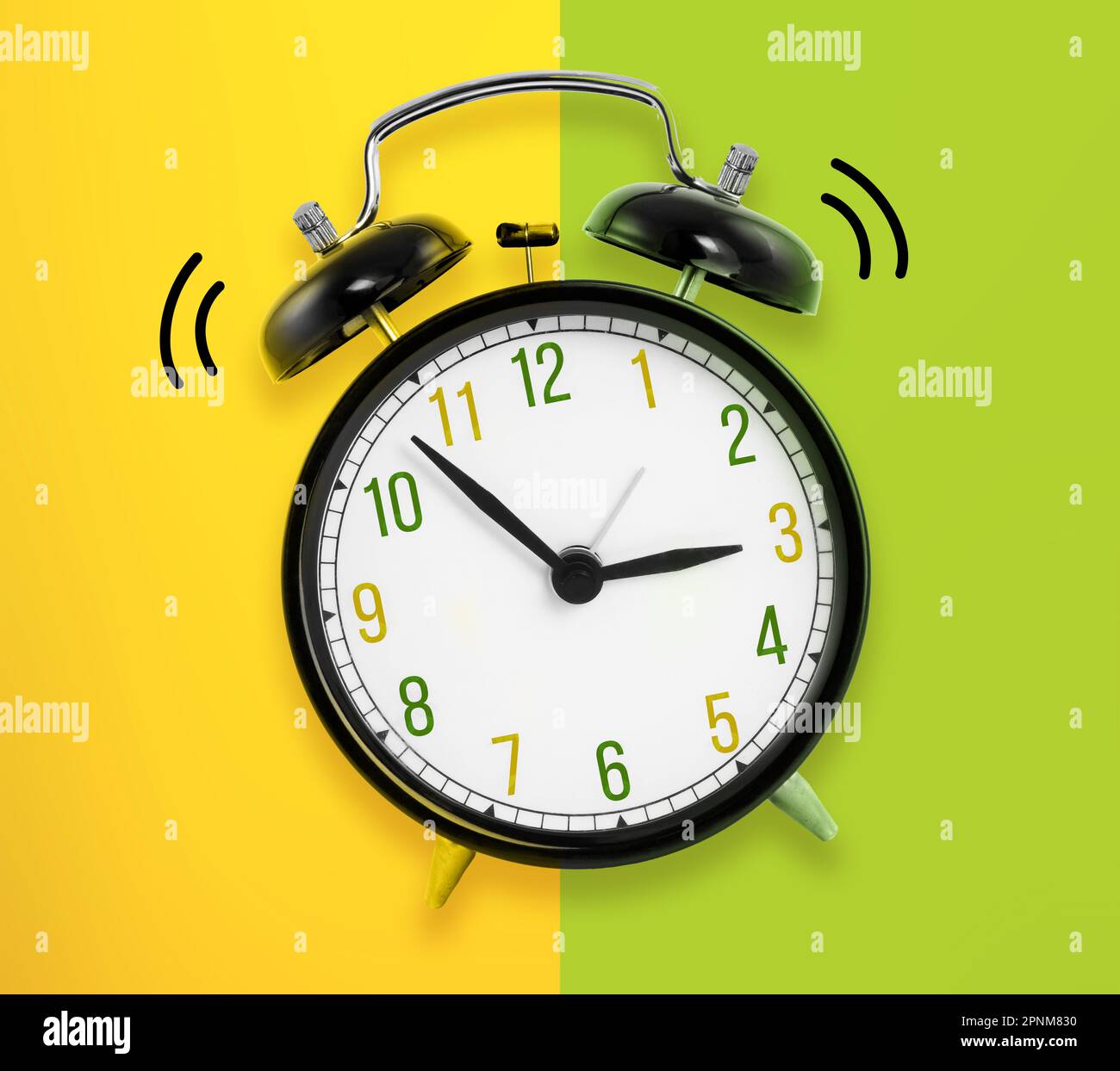 Old black clock on green and yellow background Stock Photo - Alamy