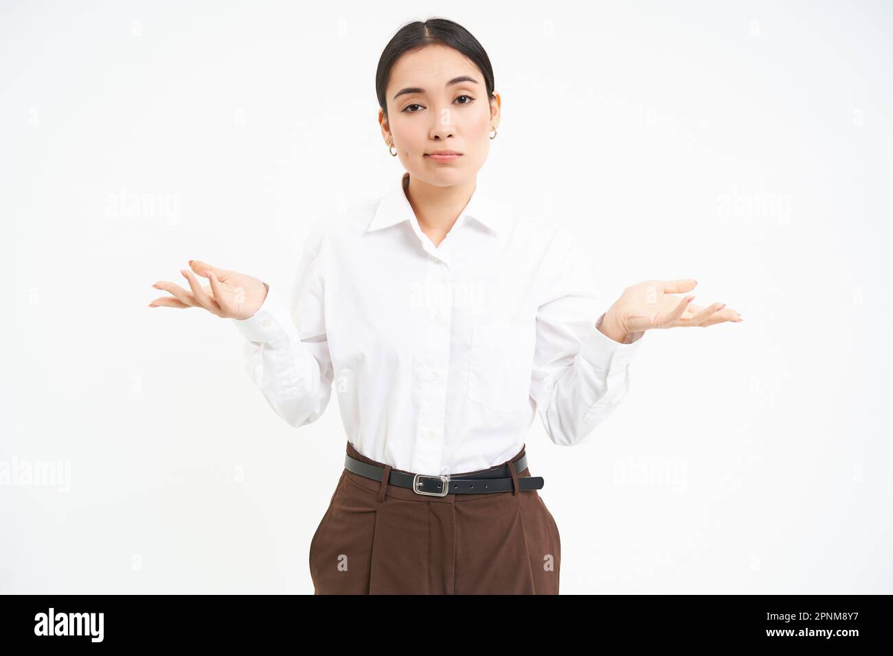 Clueless asian corporate woman, shrugs shoulders with puzzled face ...
