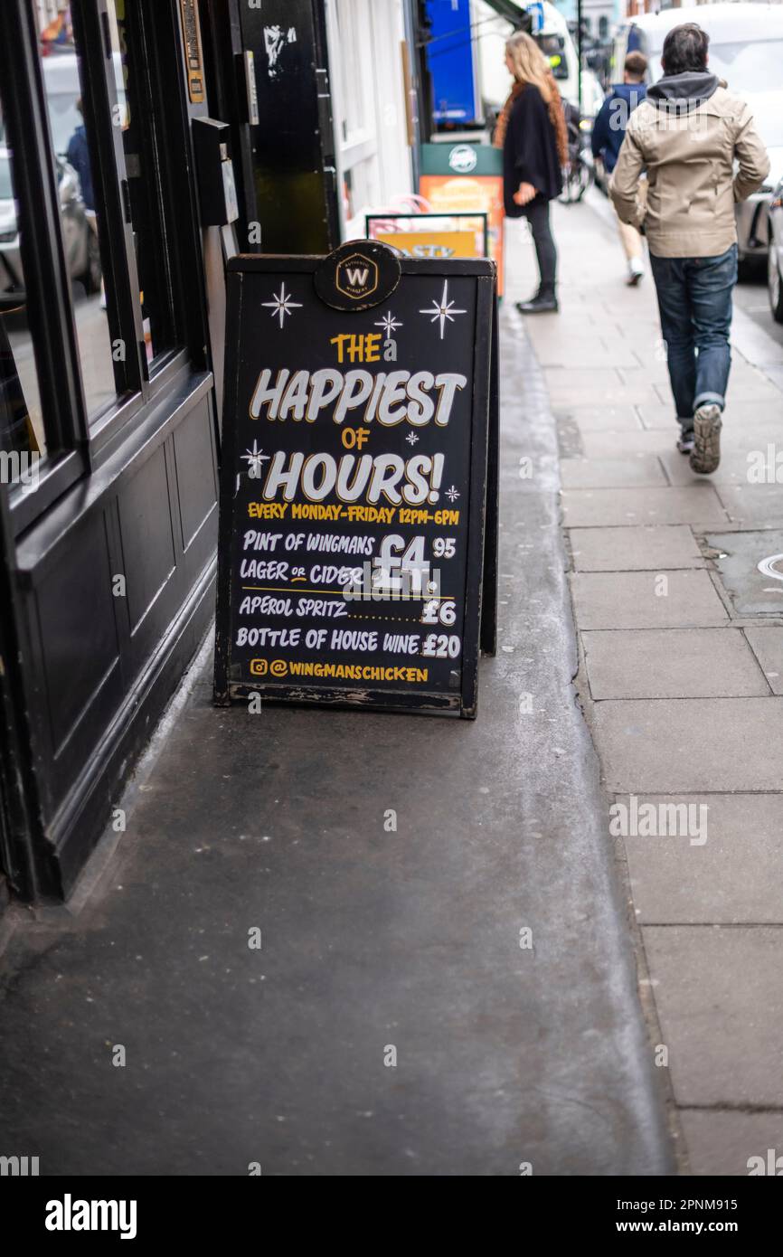 Signage outside a pub in Soho London advertising happy hour Stock Photo ...