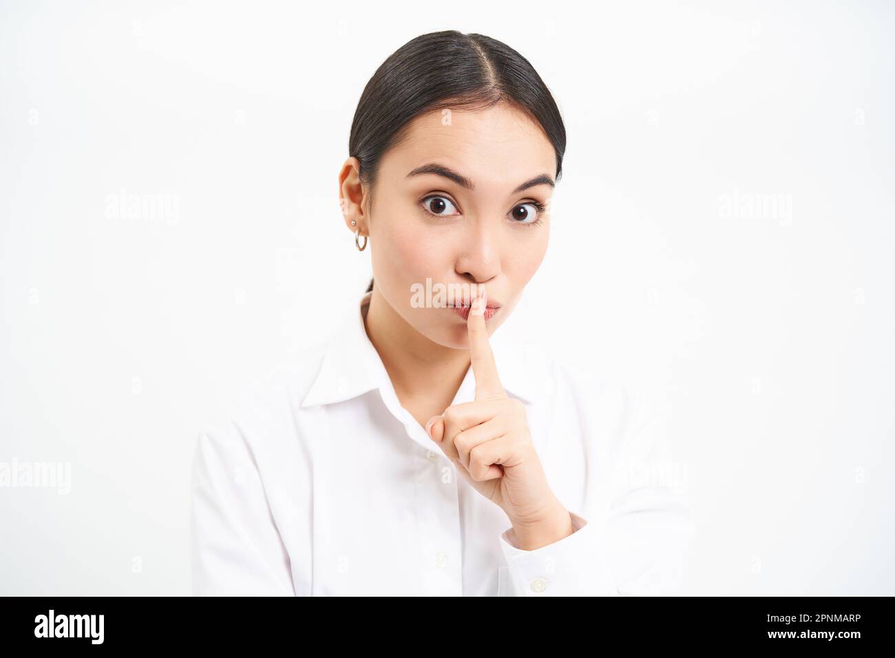Office gossips. Young woman shushing, press finger to lips, say shh ...