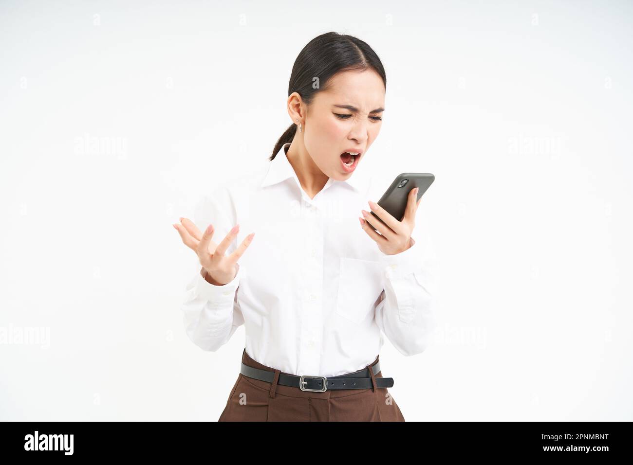Angry asian businesswoman shouts at her mobile phone with frustrated ...