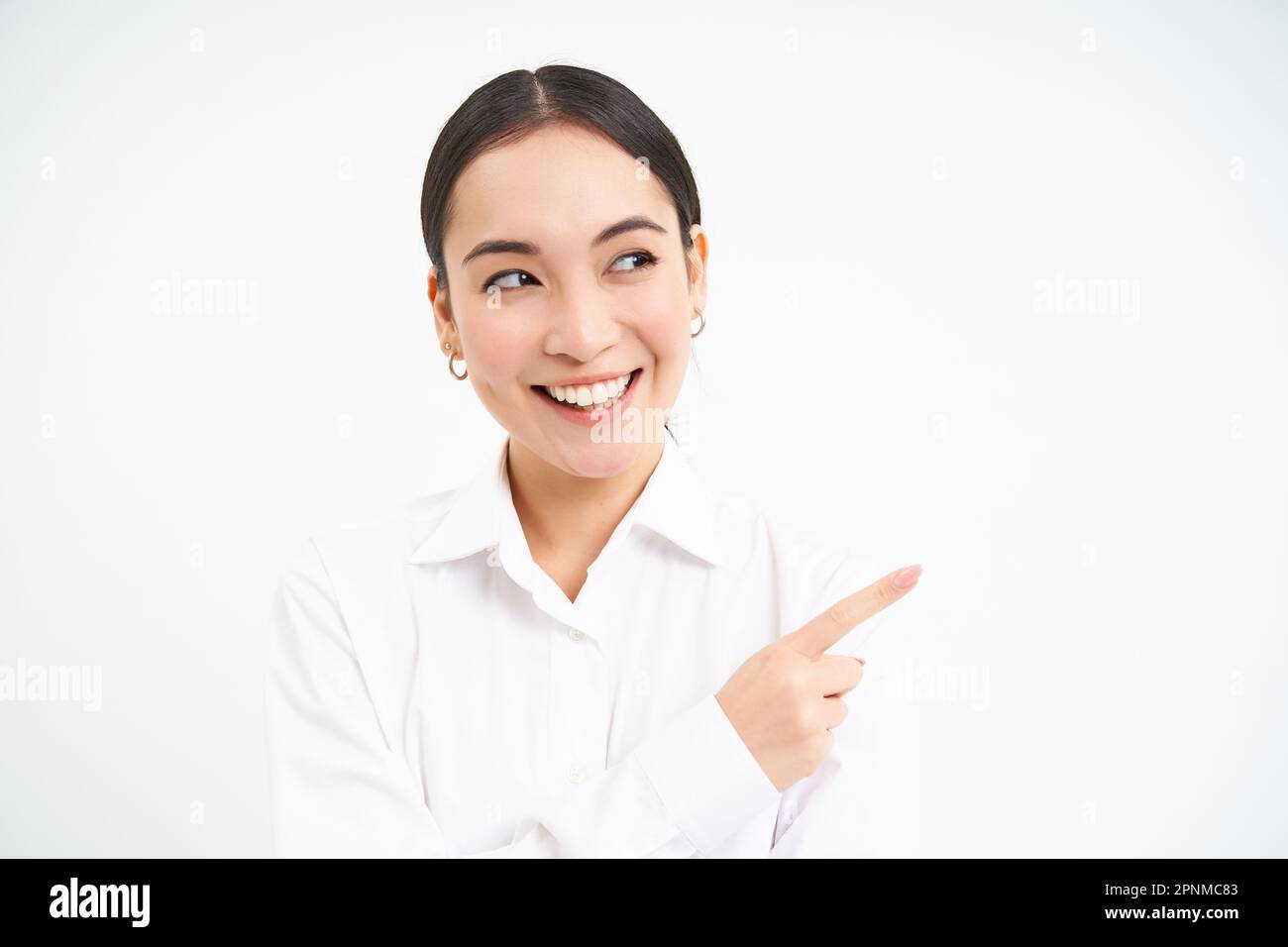 Successful korean businesswoman, pointing finger right, showing ...