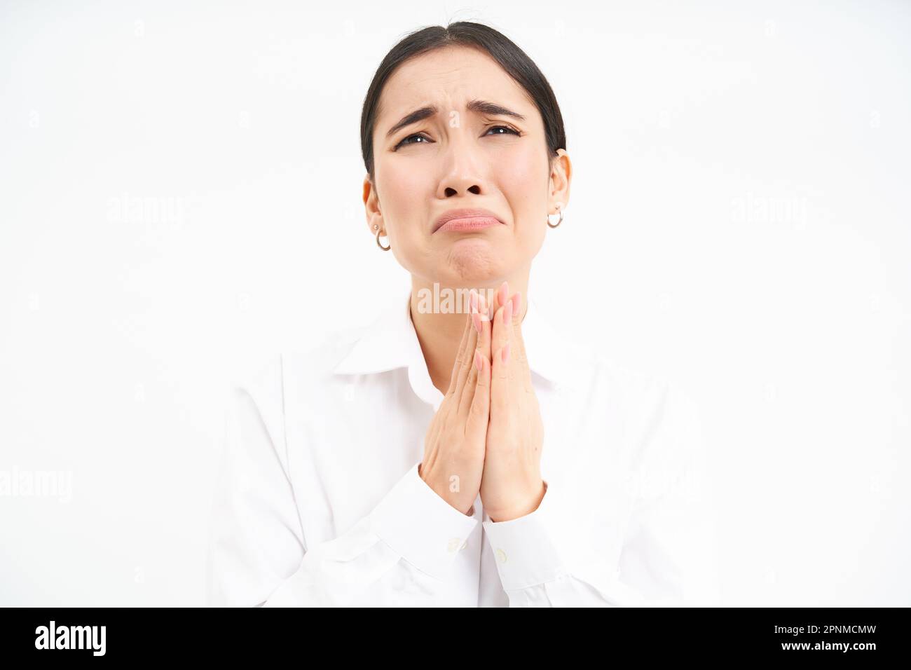 Upset asian woman looks up with desperate and sad face, complains to ...