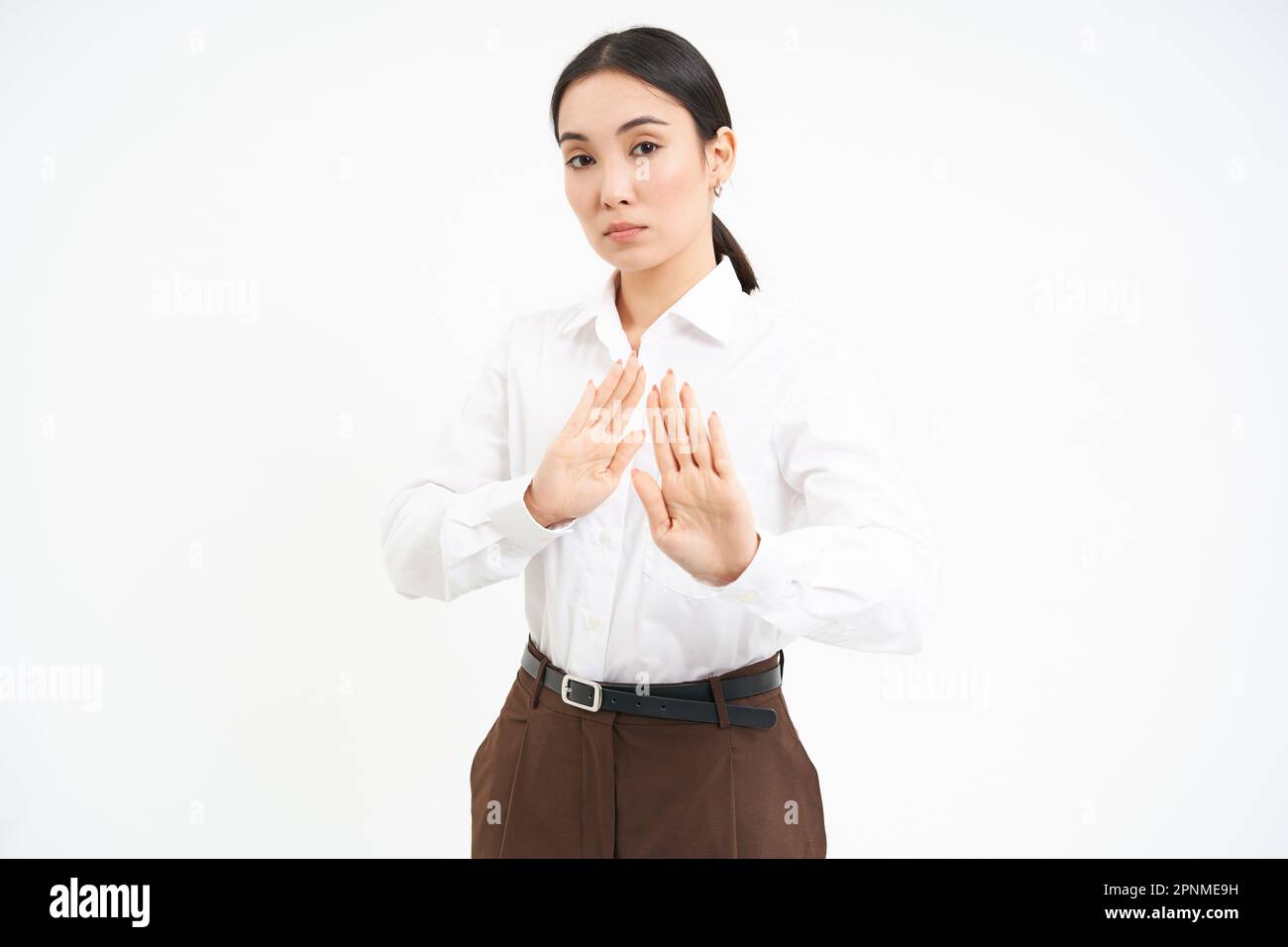 Stop, stay back. Young asian woman rejects smth, pulls away, holds ...