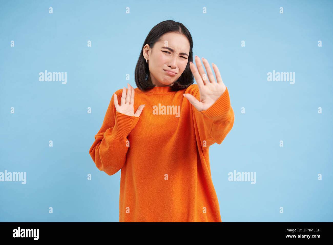 Stop it, no photos please. Upset asian girl blocks camera with hands ...