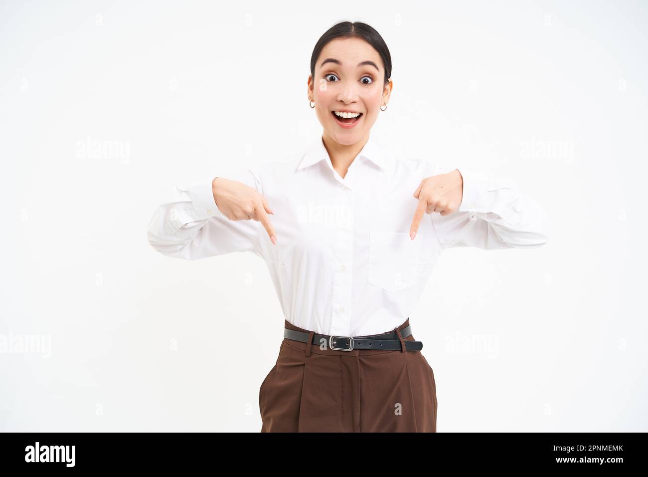Confident smiling businesswoman, asian office lady points fingers down ...