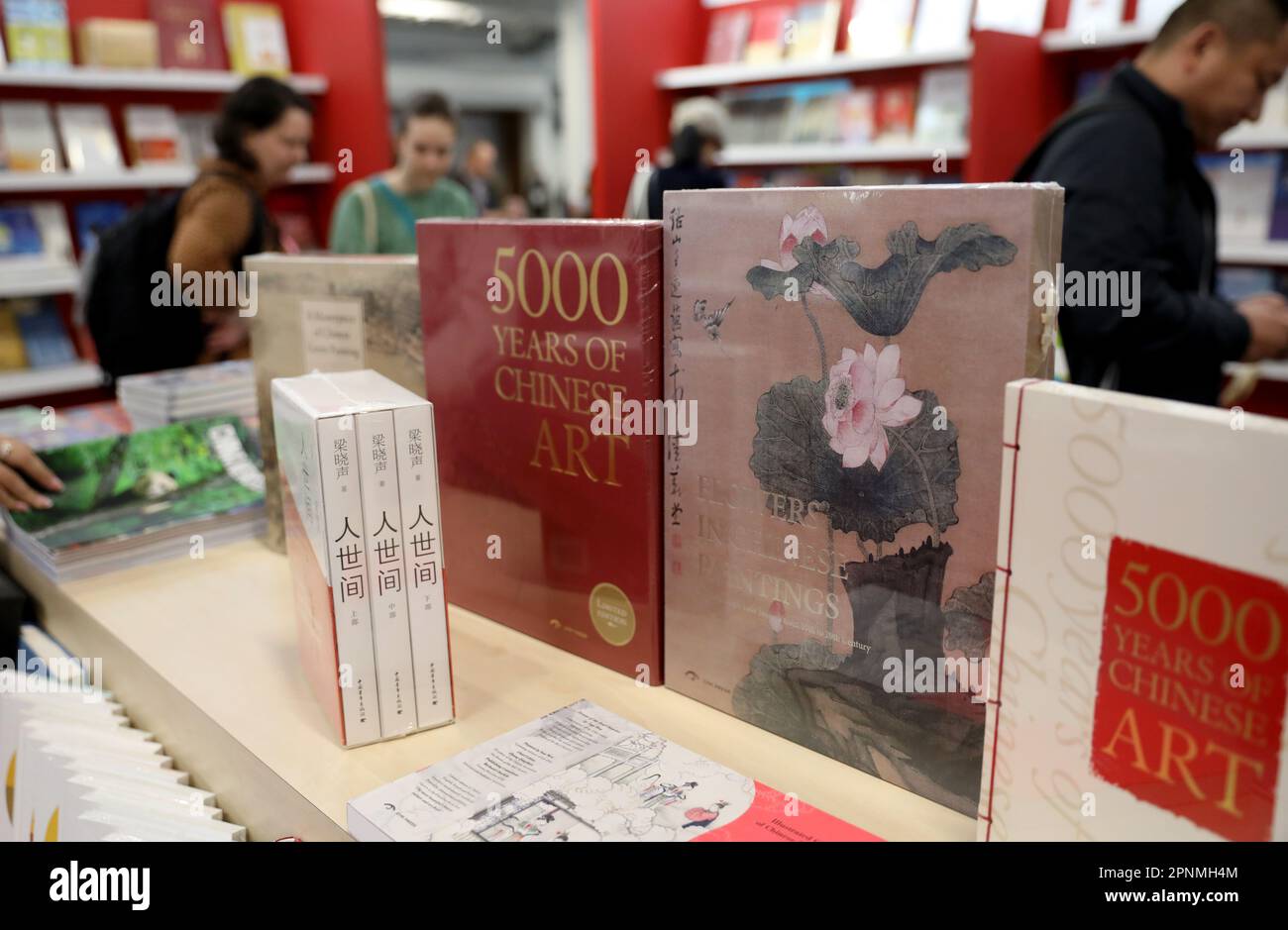 London, Britain. 18th Apr, 2023. People visit a booth displaying China ...