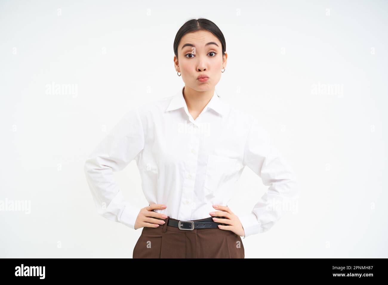 Stylish beautiful brunette woman, office employee, puckers lips and ...