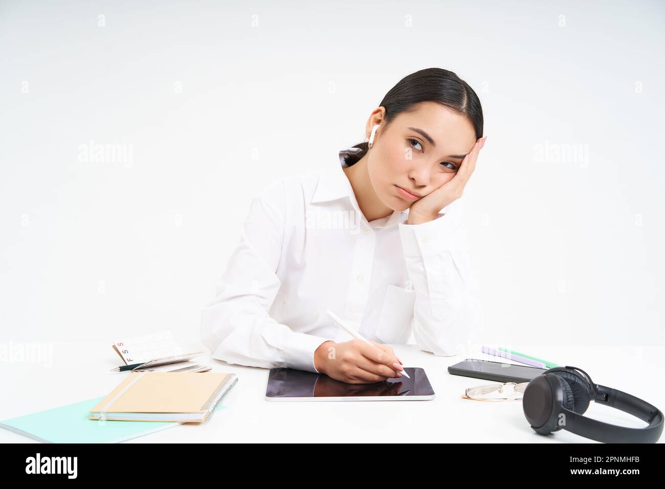 Tired and bored korean woman in office, employee sits with digital ...