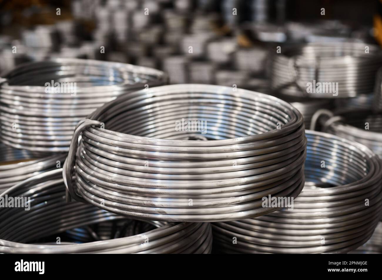 Coils of grey lead rod for bullets production at plant Stock Photo - Alamy