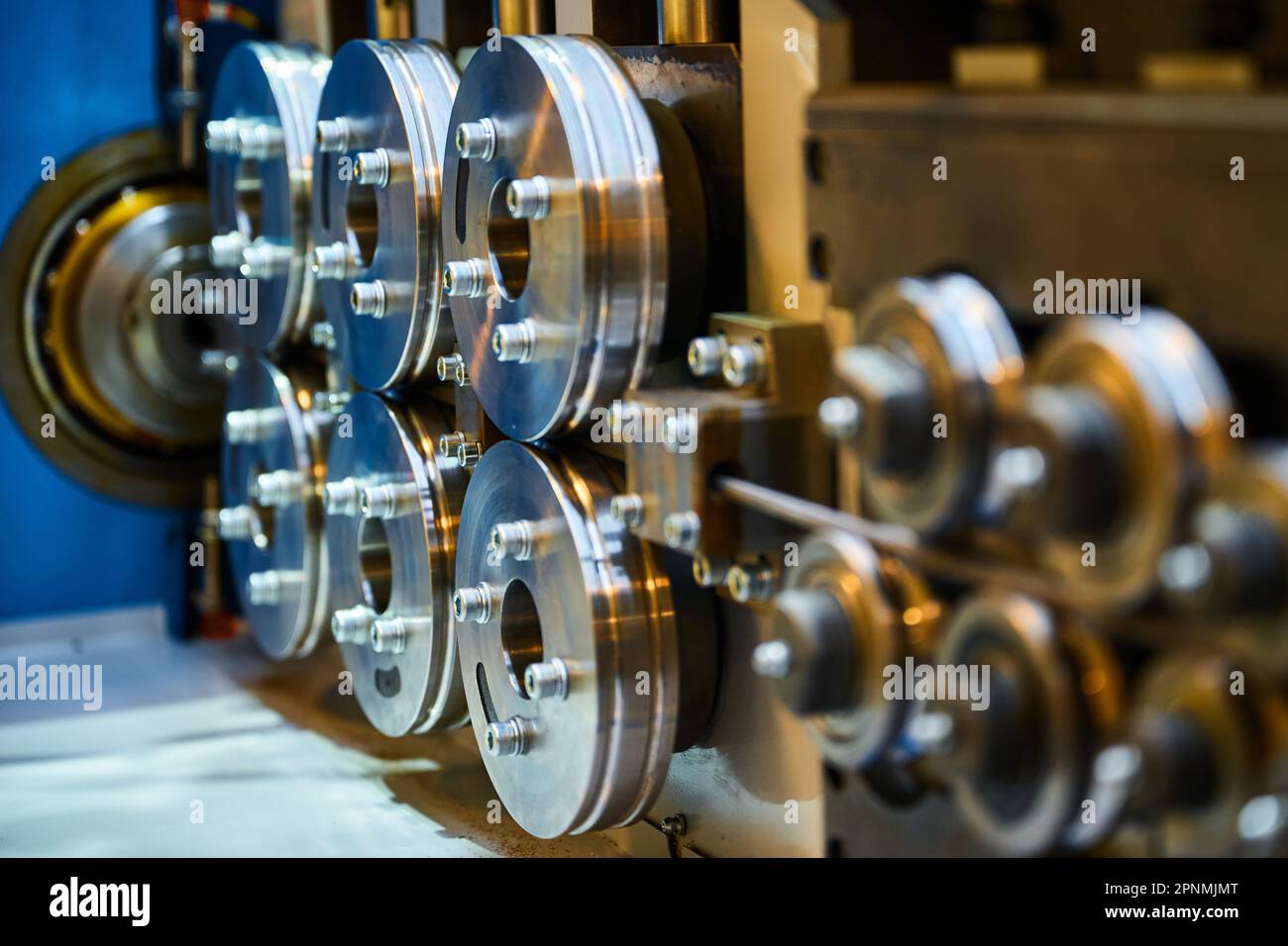 Metal cable pulled out through rollers line on machine tool Stock Photo ...