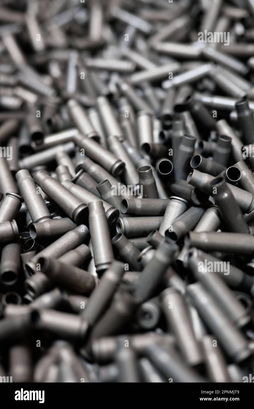 Bullet casings on dark background at armor production plant Stock Photo ...