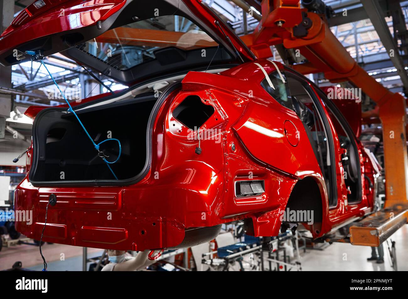 Bright red modern cars bodies in assembling workshop Stock Photo - Alamy