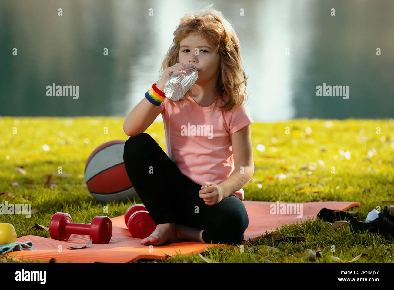 Child boy eating healthy food, drinking water after exercise. Fitness ...