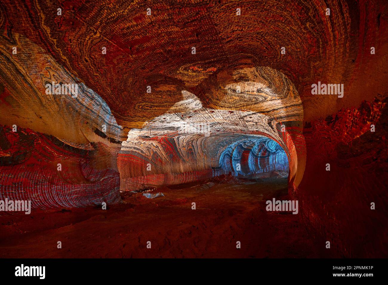 Outgoing tunnel of salt quarry with red patterns on walls Stock Photo ...