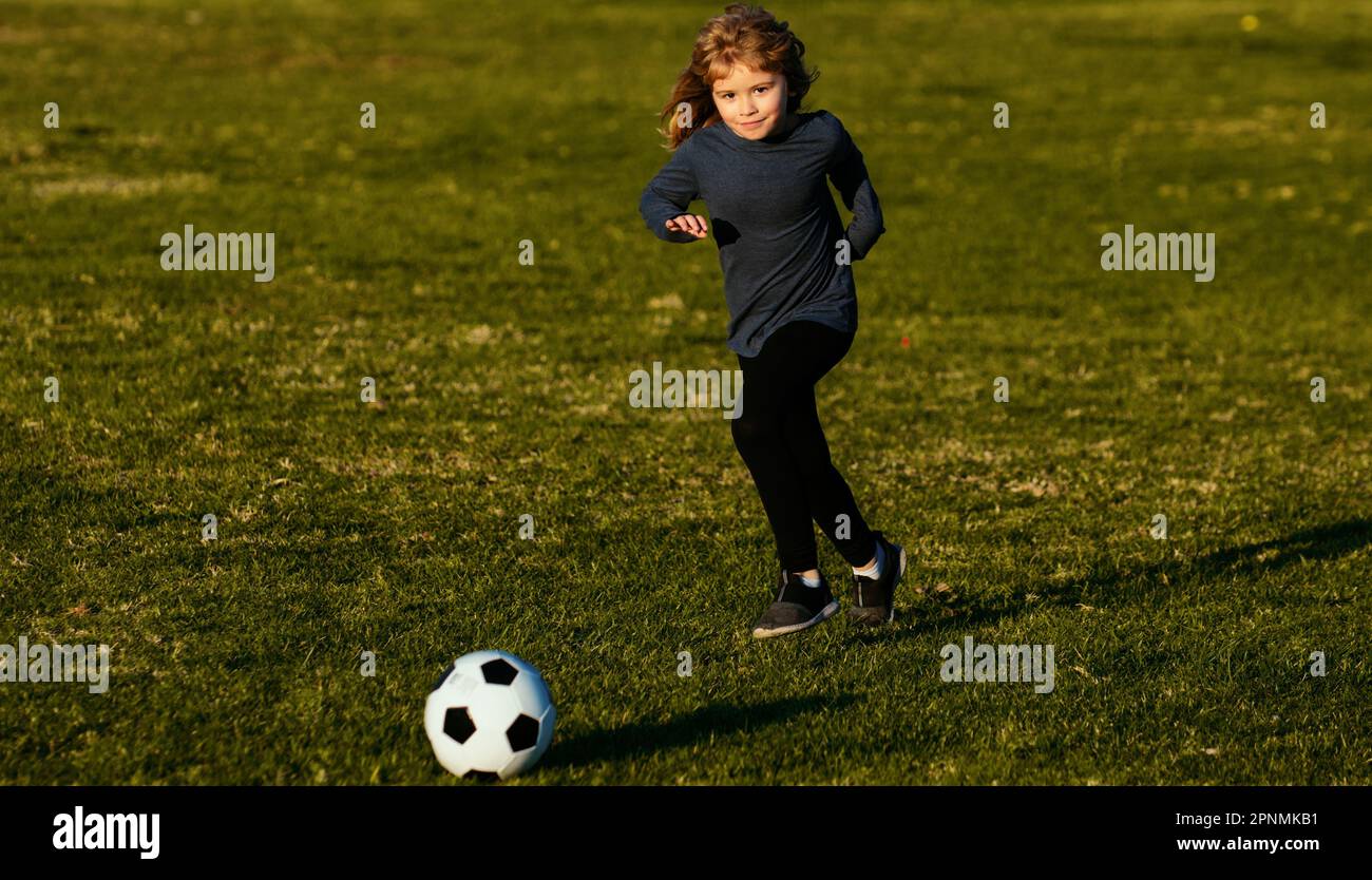 Soccer kid. Kids play football on summer stadium field. Little child ...