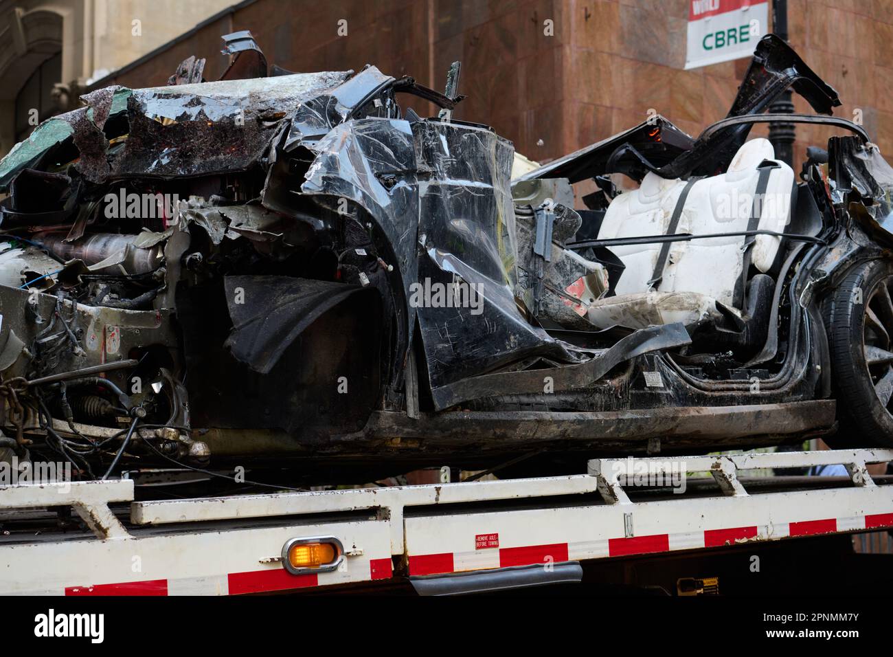 New York, New York, USA. 19th Apr, 2023. A demolished Tesla is removed ...