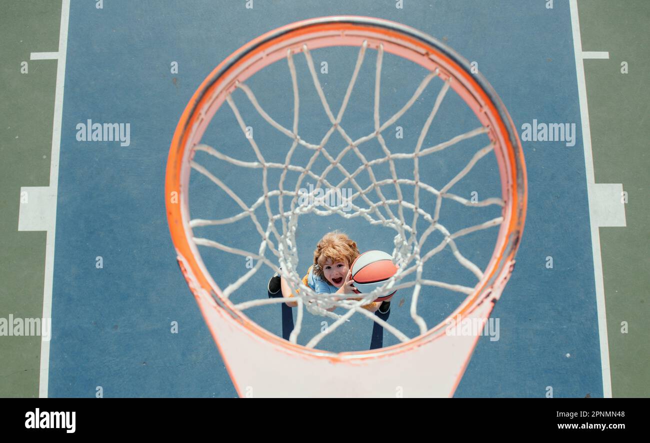 Kid playing basketball. Cheerful boy basketball player holding game ...
